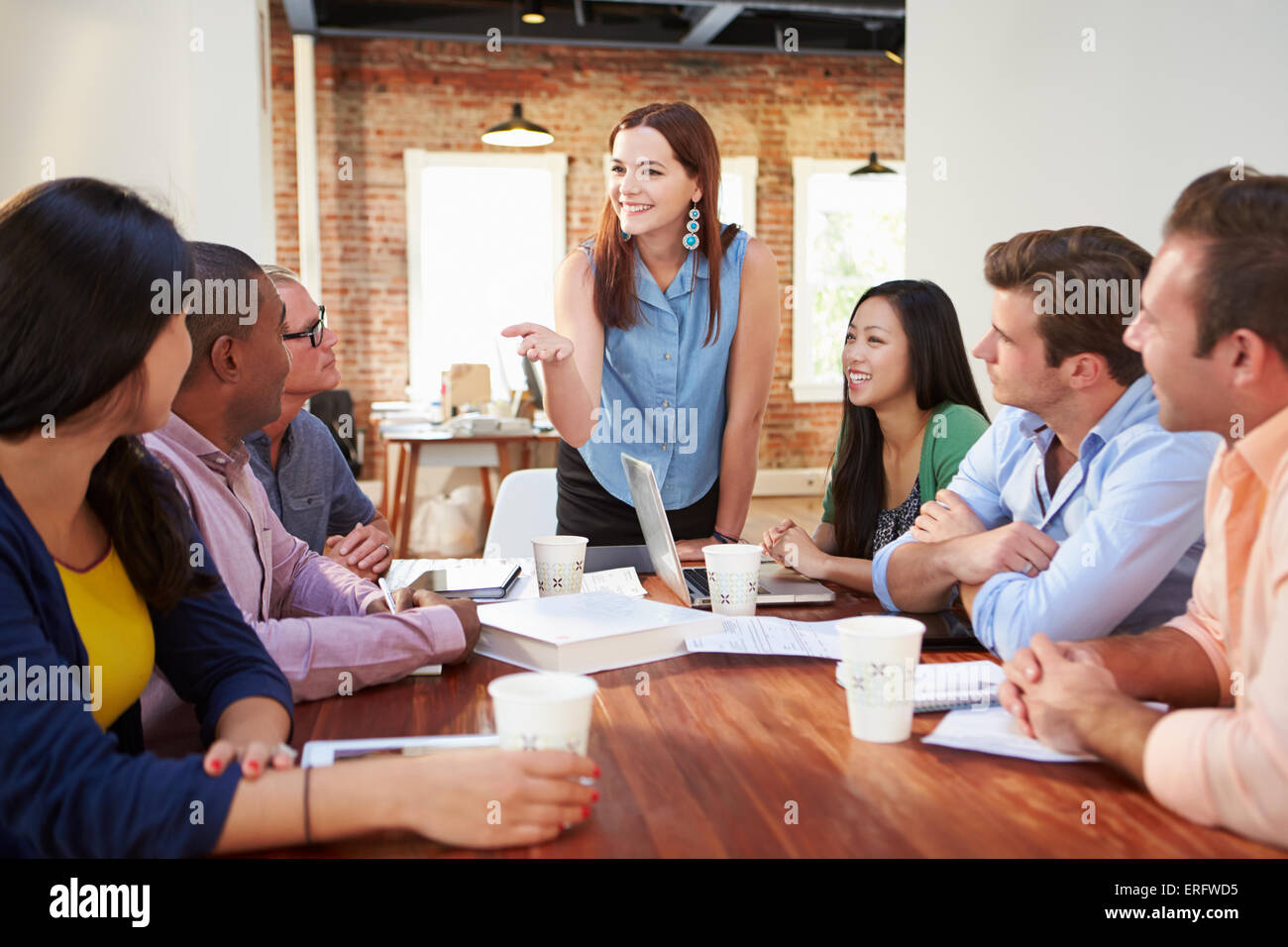 Female Boss Addressing Office Workers At Meeting Stock Photo - Alamy