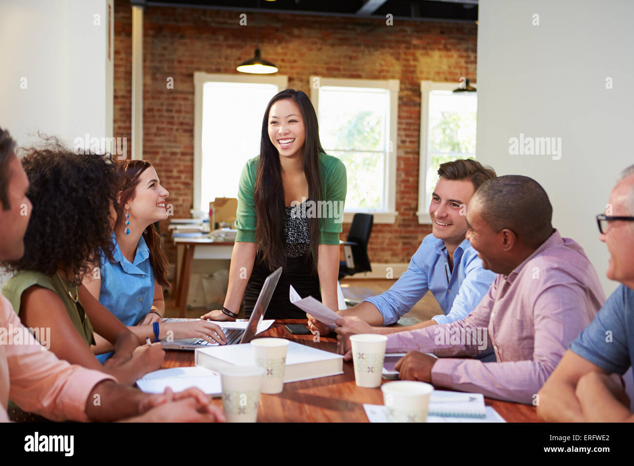 Female Boss Addressing Office Workers At Meeting Stock Photo - Alamy