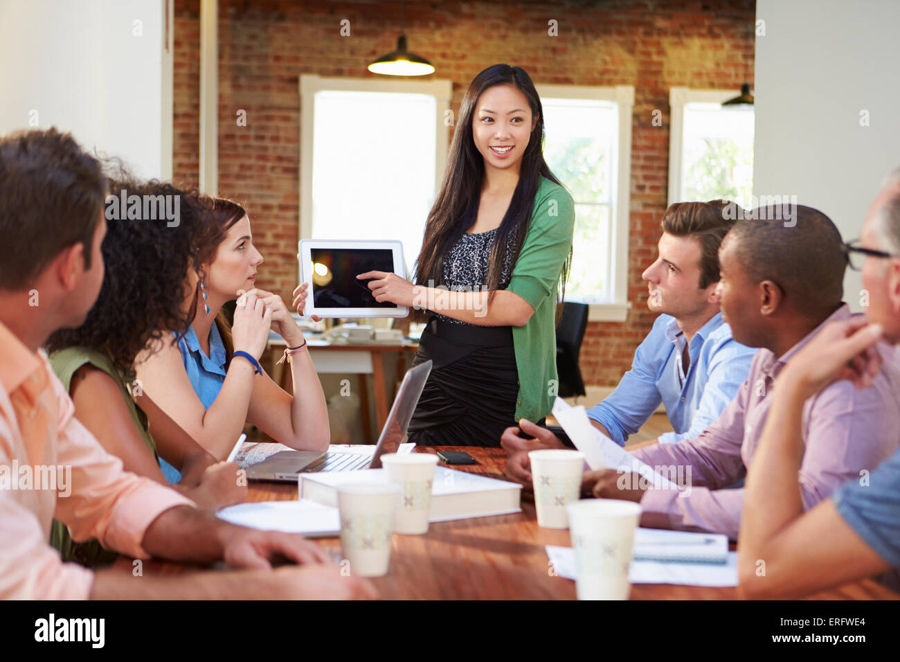 Female Boss Addressing Office Workers At Meeting Stock Photo - Alamy