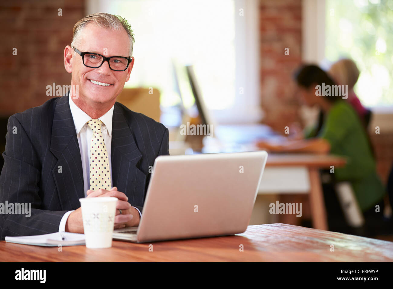Man Working At Laptop In Contemporary Office Stock Photo - Alamy