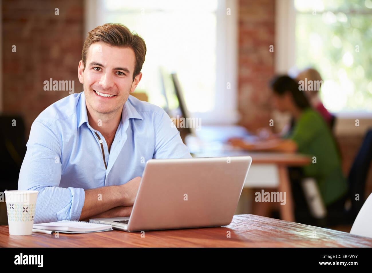 Man Working At Laptop In Contemporary Office Stock Photo - Alamy