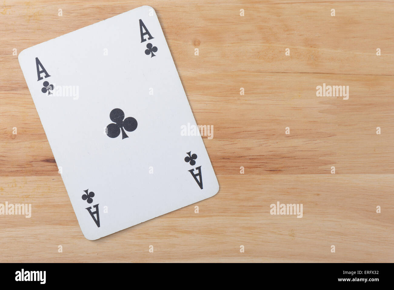 Black ace card on a wood background Stock Photo - Alamy