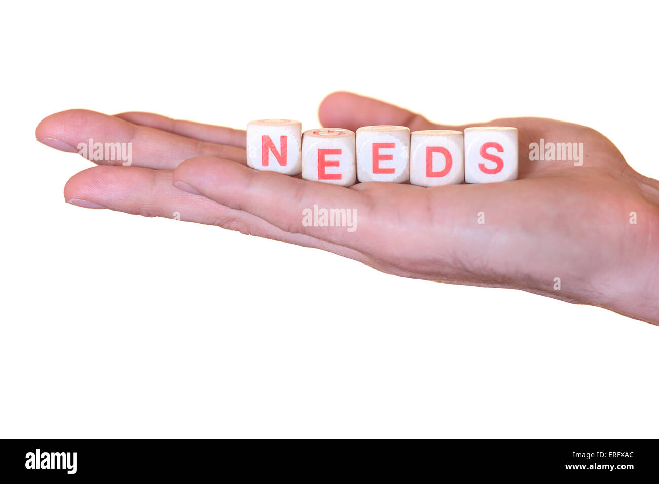 The word needs written with wooden dice on the he palm of the hand ...