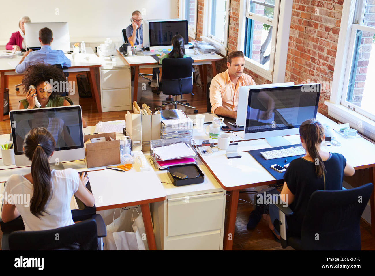 Wide Angle View Of Busy Design Office With Workers At Desks Stock Photo ...
