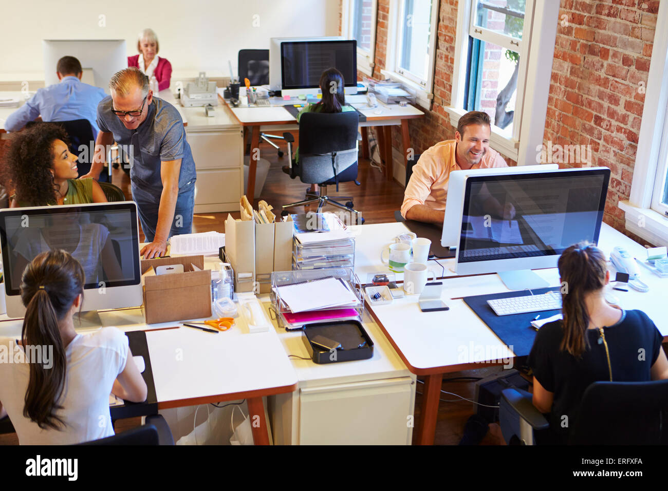 Wide Angle View Of Busy Design Office With Workers At Desks Stock Photo ...