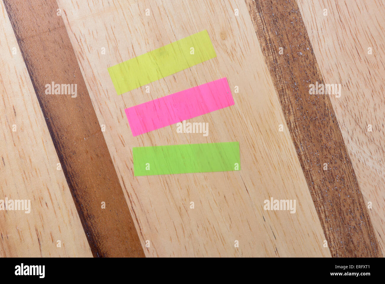 Notes three colours horizontal mix on wood background Stock Photo - Alamy