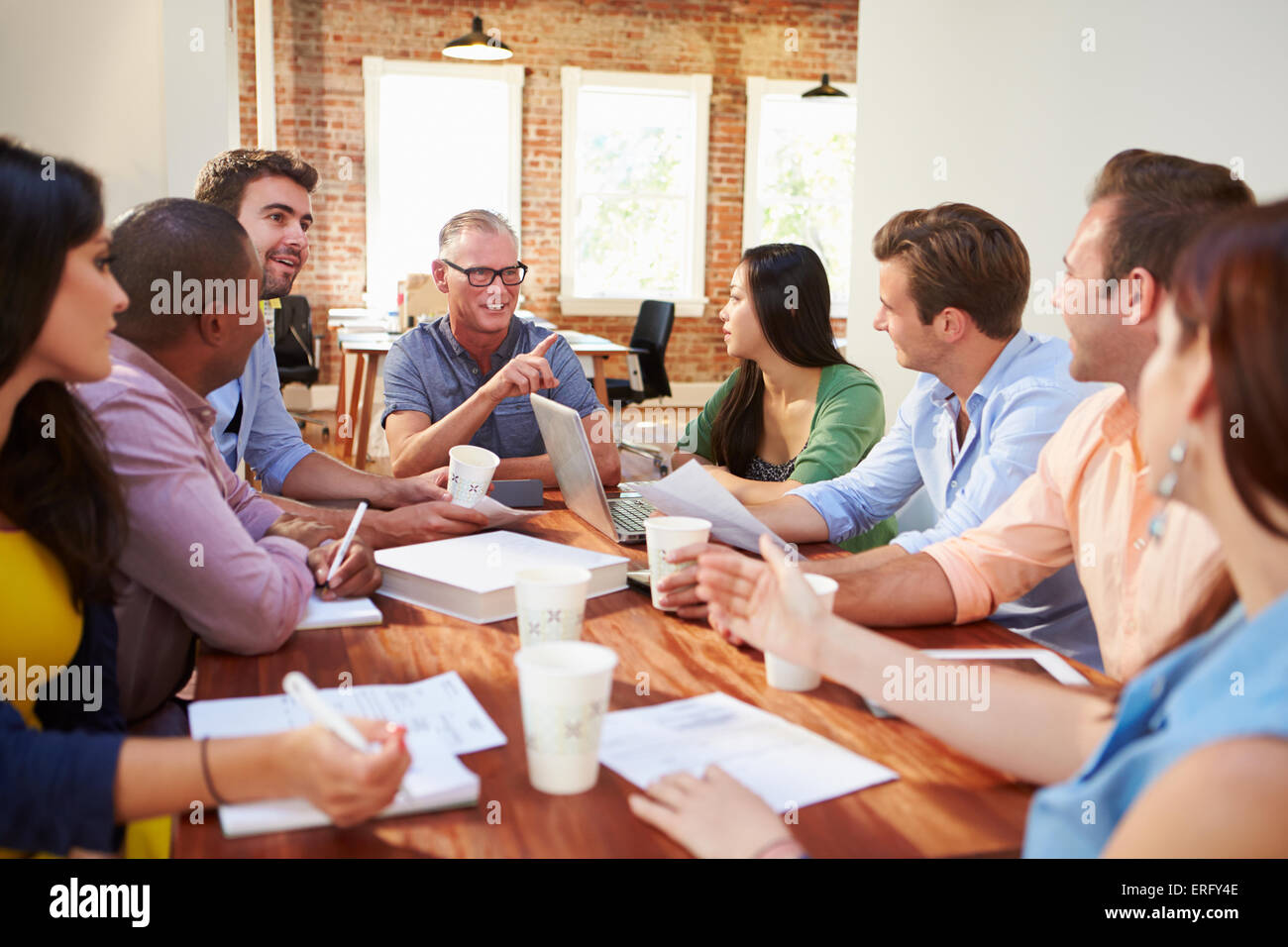 Group Of Office Workers Meeting To Discuss Ideas Stock Photo - Alamy
