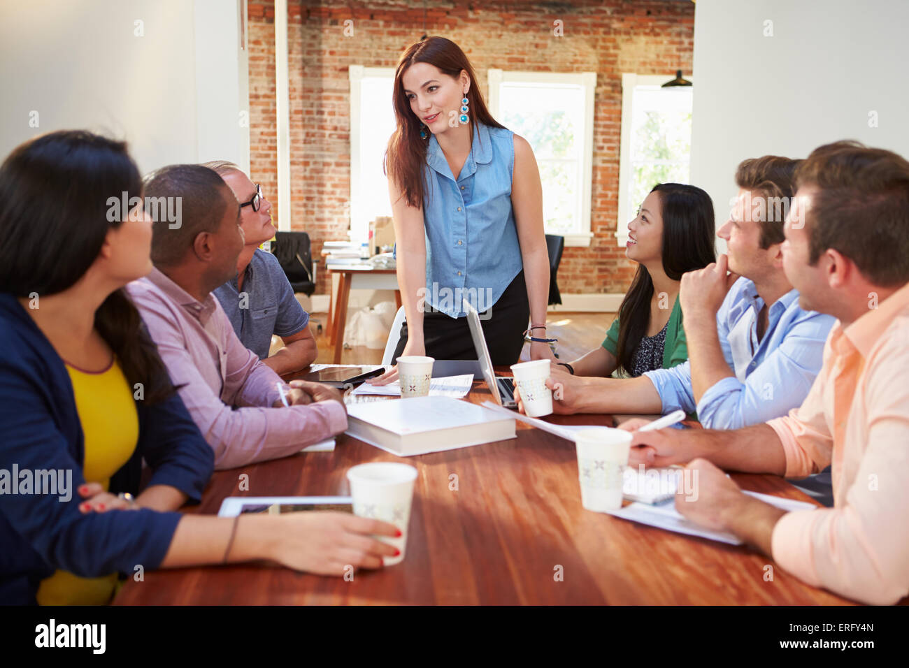 Female Boss Addressing Office Workers At Meeting Stock Photo - Alamy
