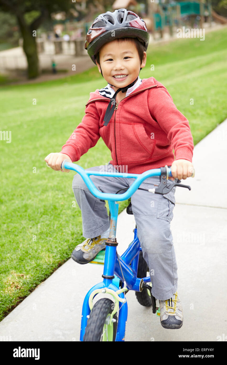 Young Boy Riding Bike In Park Stock Photo - Alamy