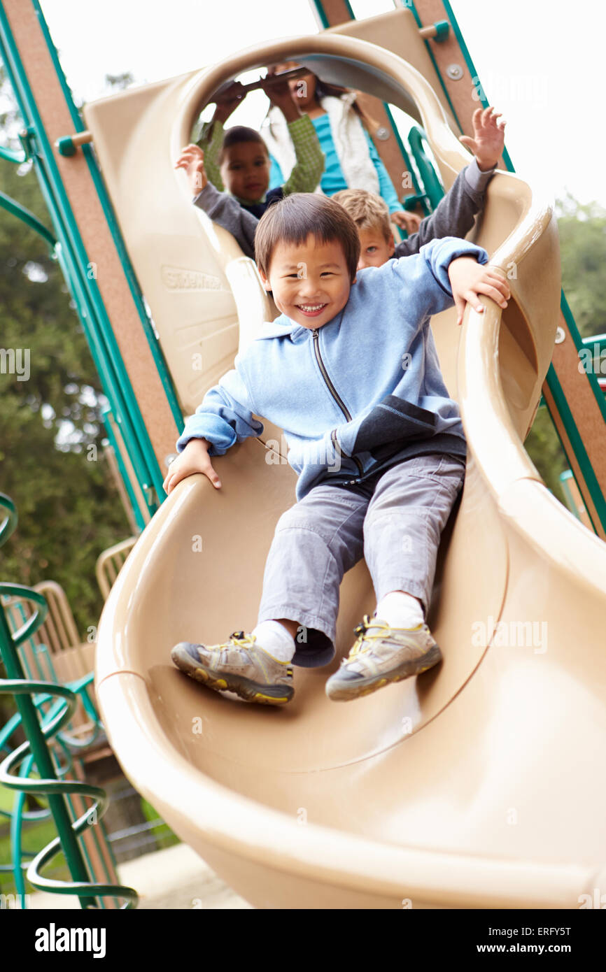 Young Boy Playing On Slide In Playground Stock Photo - Alamy