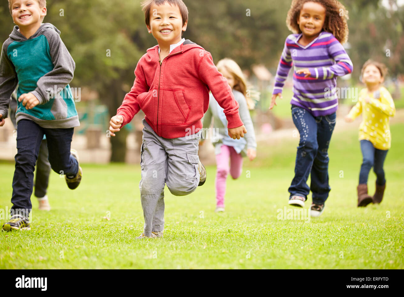 Group Of Young Children Running Towards Camera In Park Stock Photo - Alamy