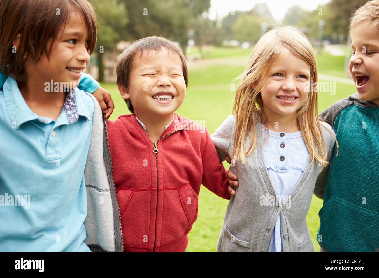 Group Of Young Children Hanging Out In Park Stock Photo - Alamy