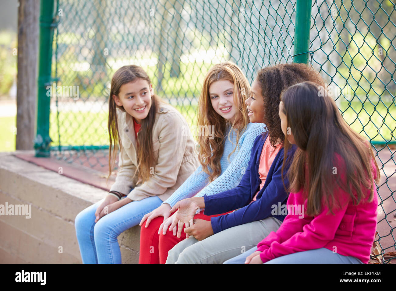 Four Young Girls Hanging Out Together In Park Stock Photo - Alamy