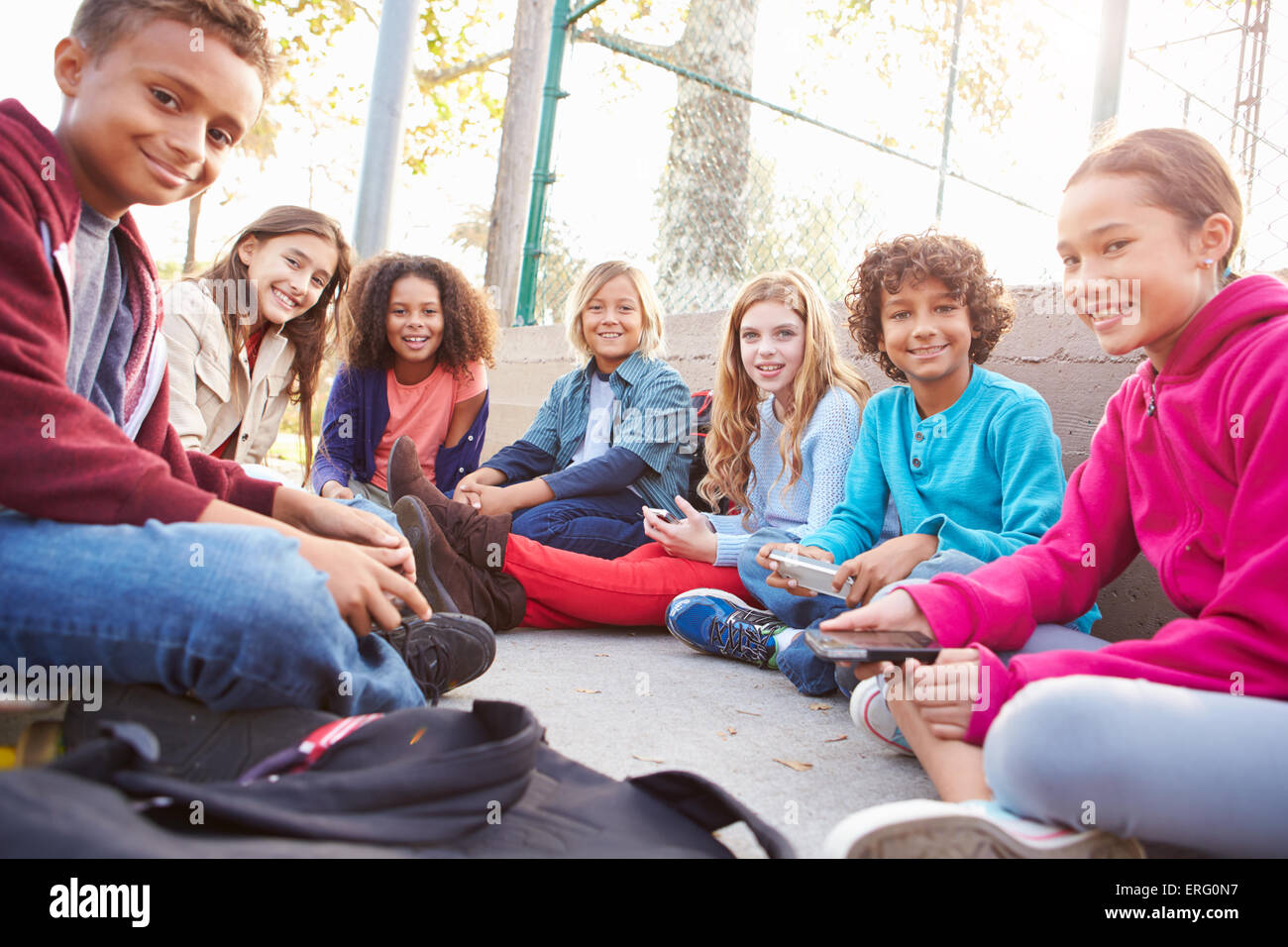 Group Of Young Children Hanging Out In Playground Stock Photo - Alamy