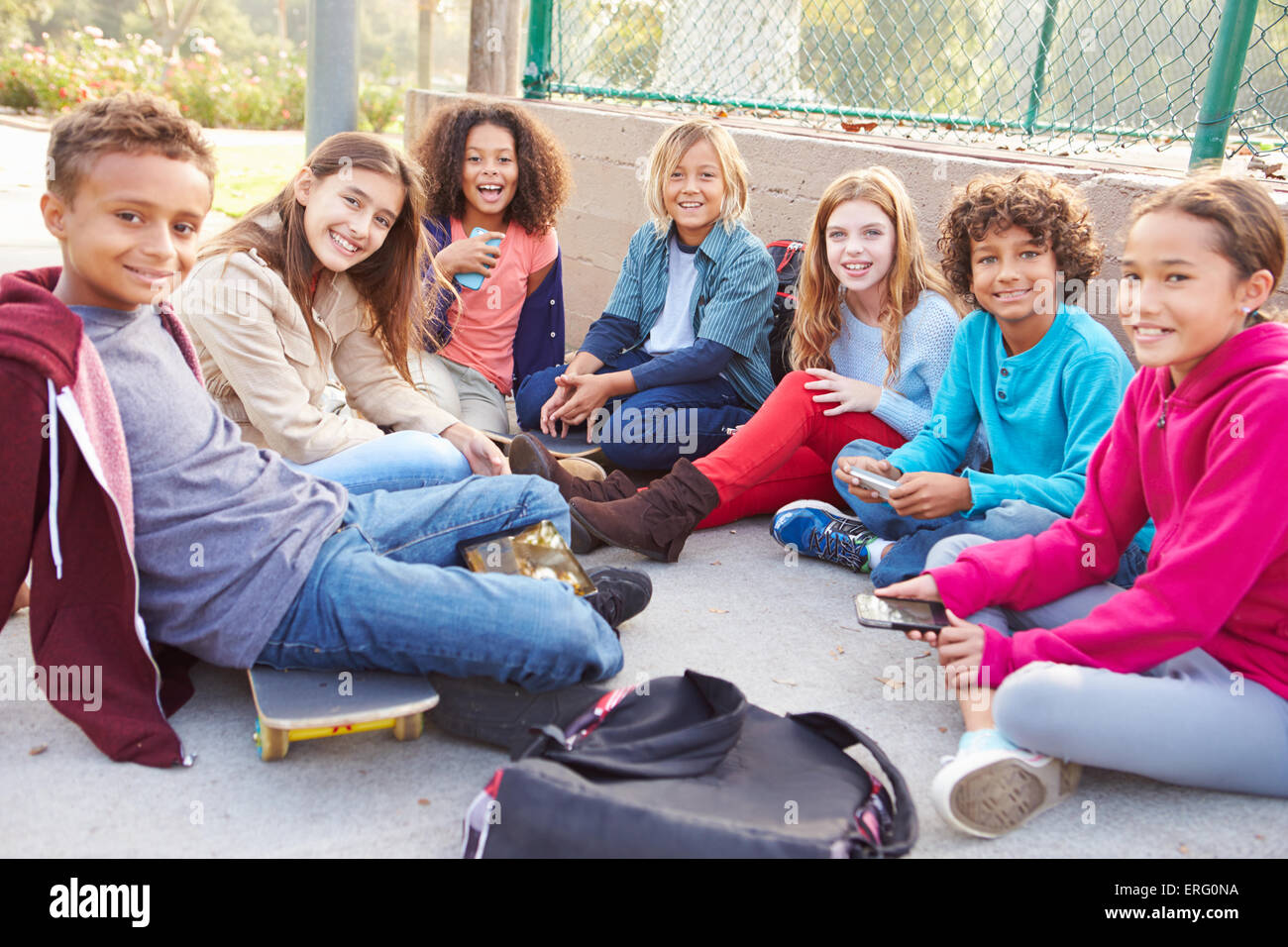 Group Of Young Children Hanging Out In Playground Stock Photo - Alamy
