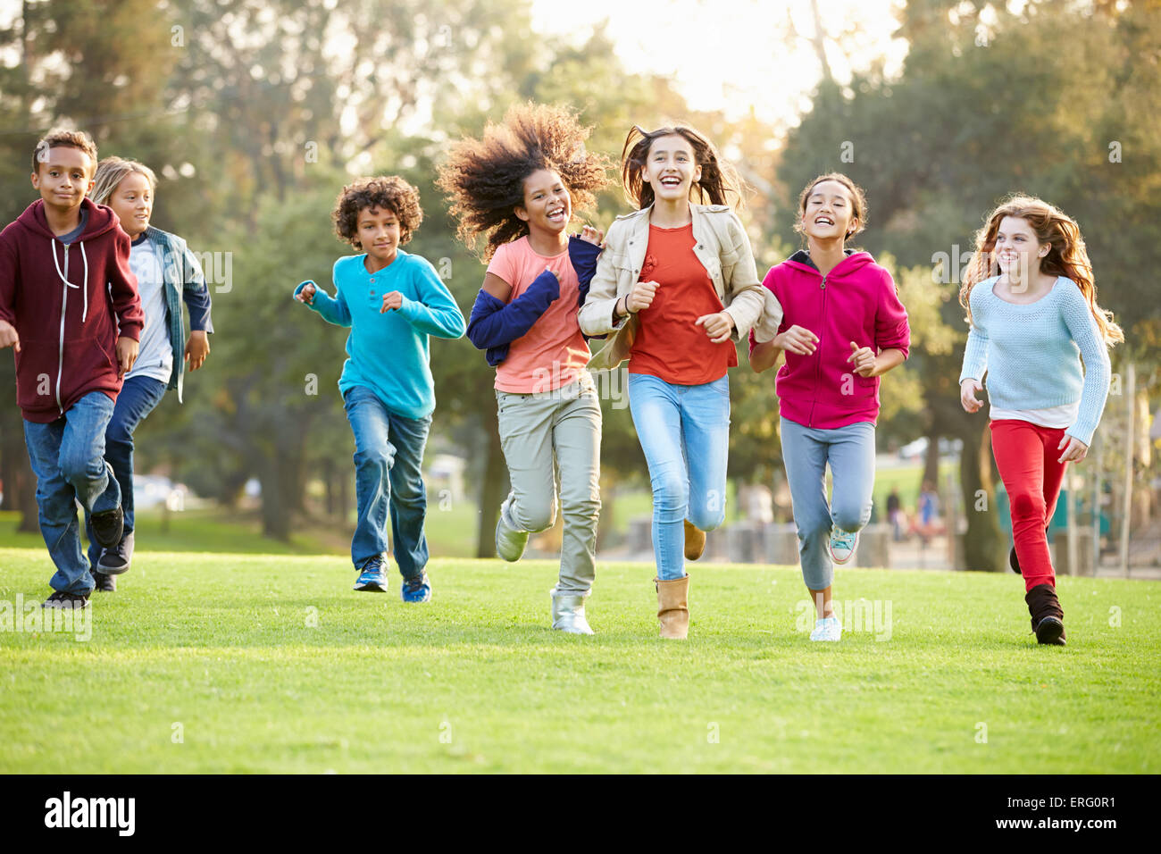 Group Of Young Children Running Towards Camera In Park Stock Photo - Alamy