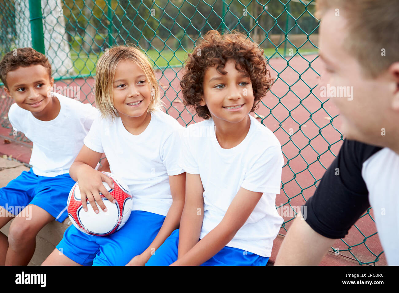 Youth Football Team Training With Coach Stock Photo - Alamy
