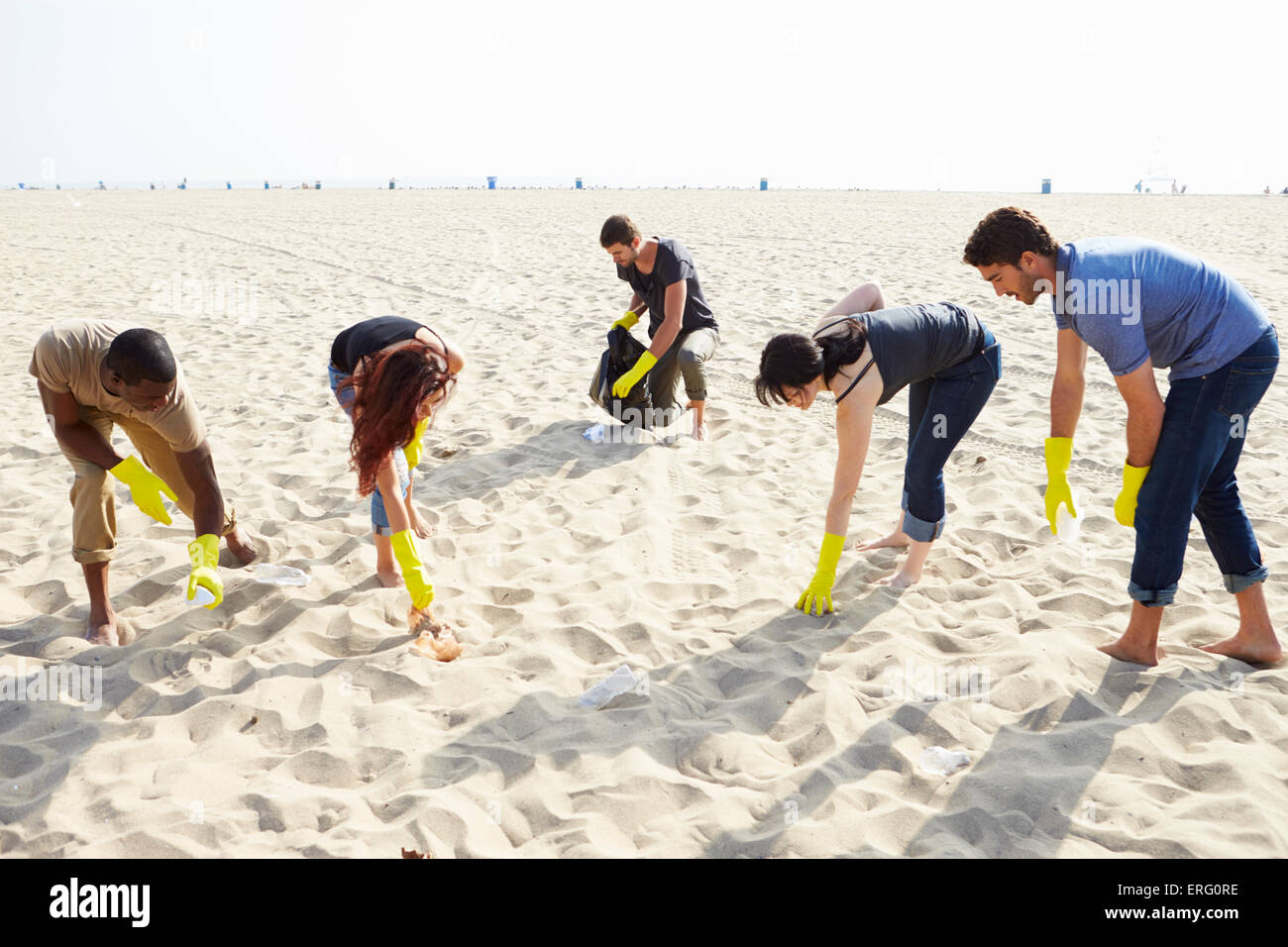 Group Of Volunteers Tidying Up Rubbish On Beach Stock Photo - Alamy