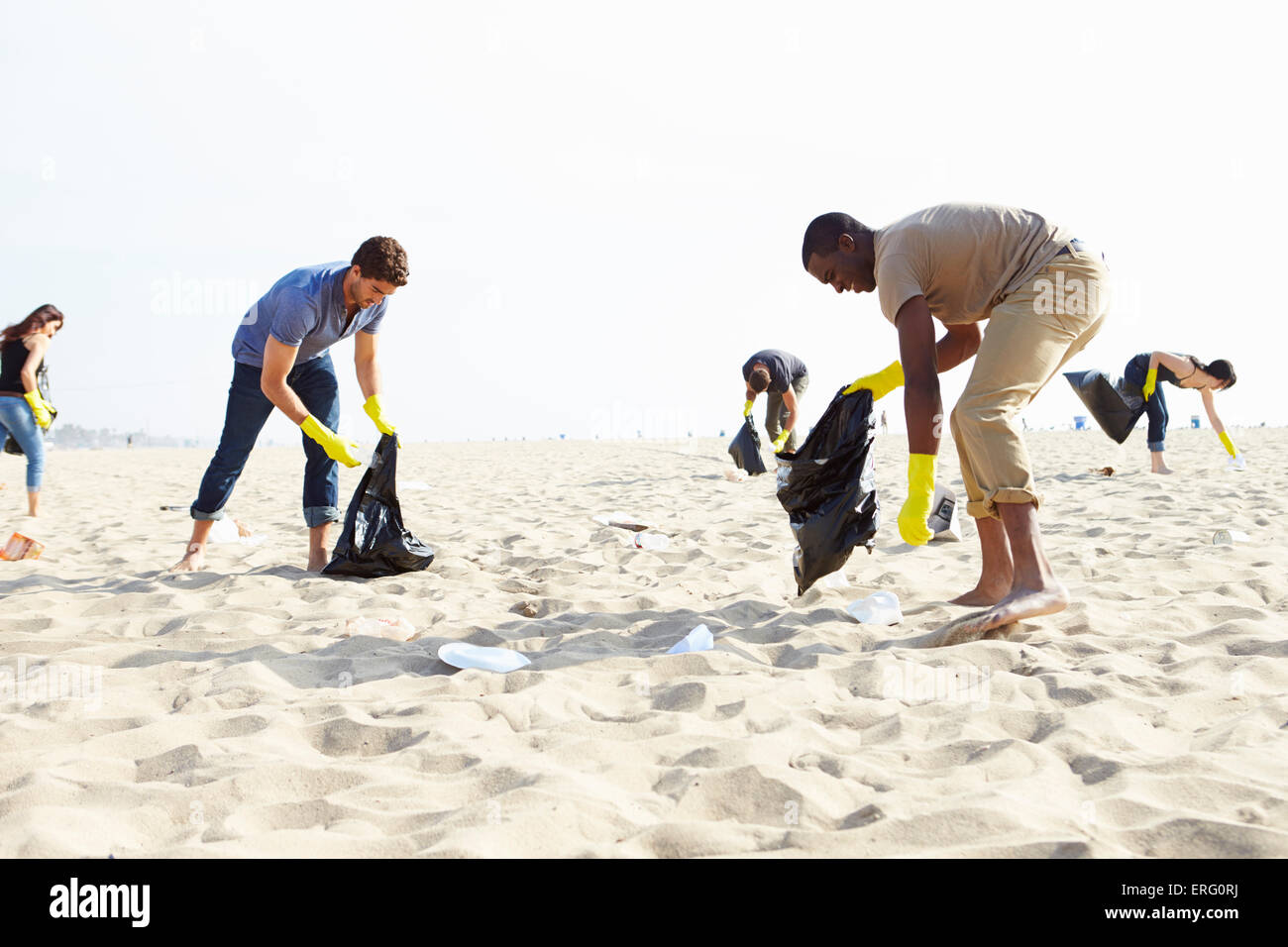 Group Of Volunteers Tidying Up Rubbish On Beach Stock Photo - Alamy