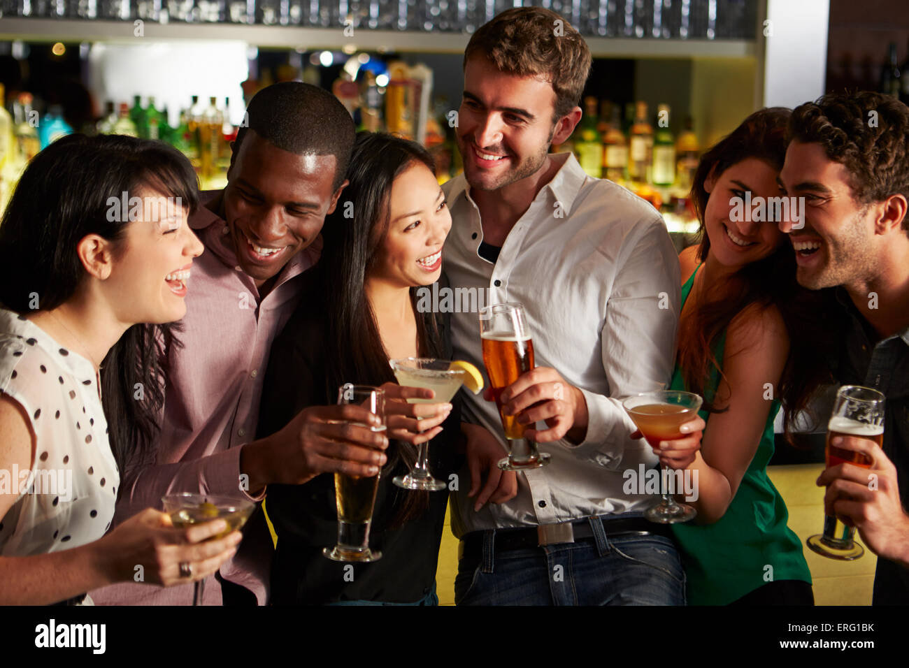 Group Of Friends Enjoying Drink In Bar Stock Photo - Alamy