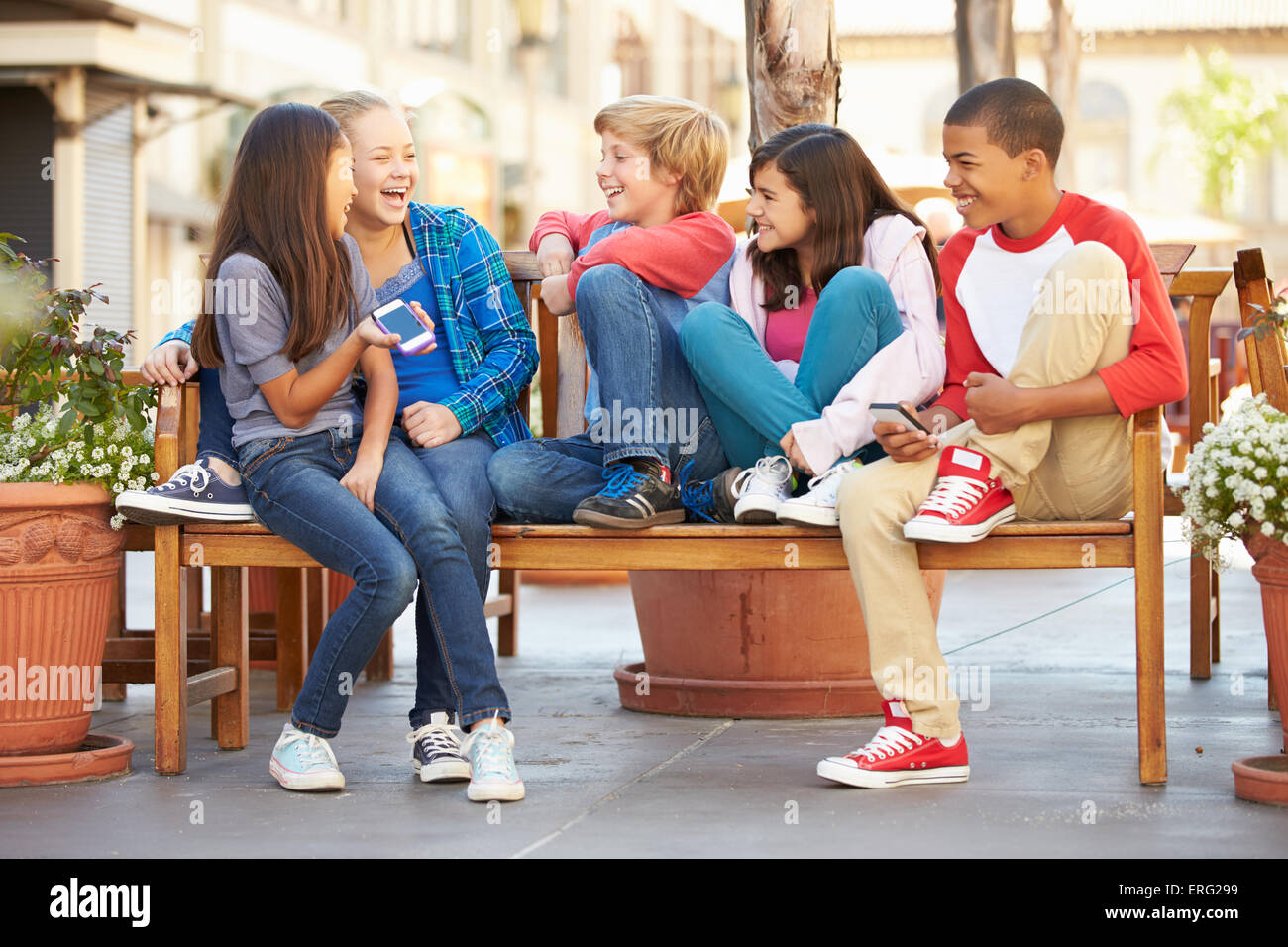 Children sitting on bench in hi-res stock photography and images - Alamy