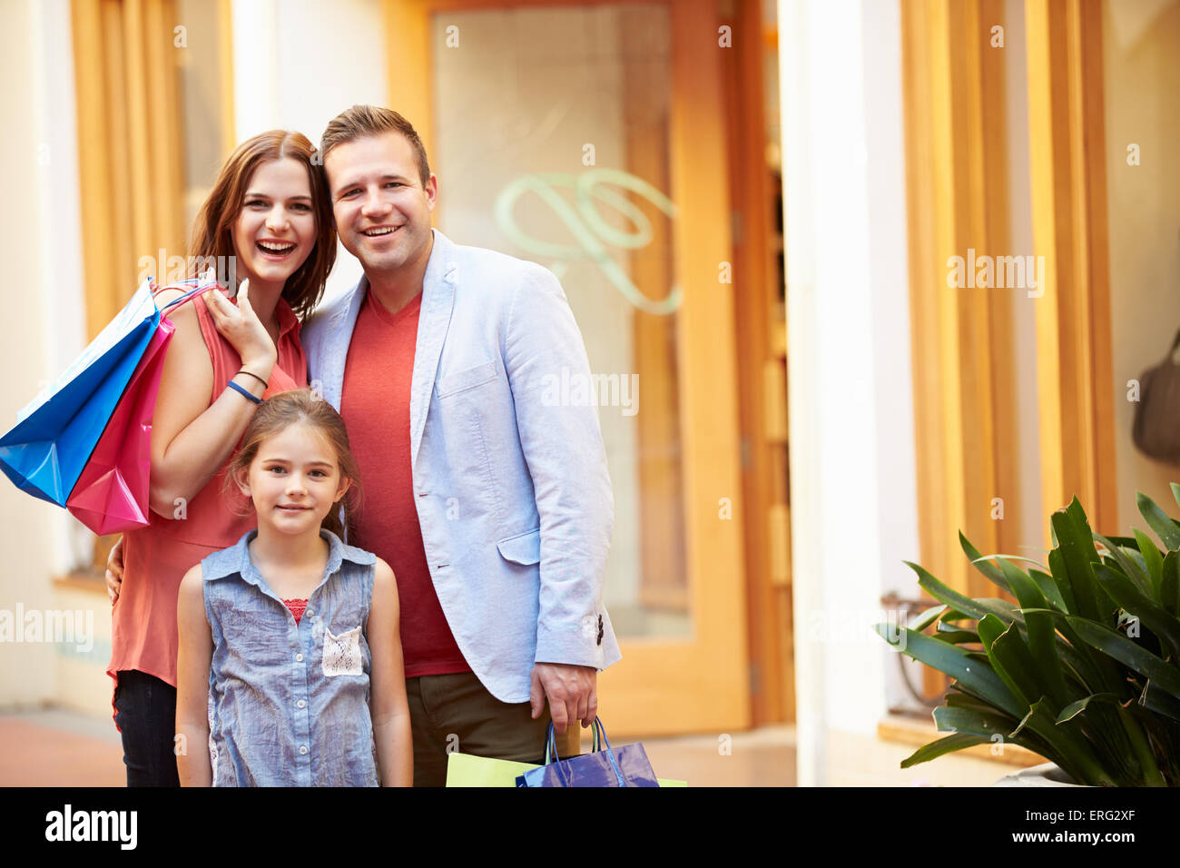 Family Walking Through Mall With Shopping Bags Stock Photo - Alamy