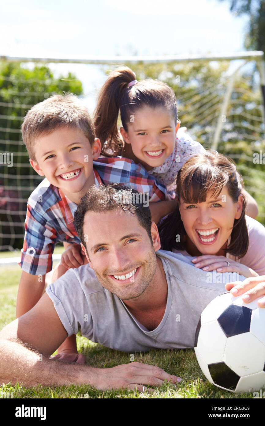 Family Playing Football In Garden Together Stock Photo - Alamy
