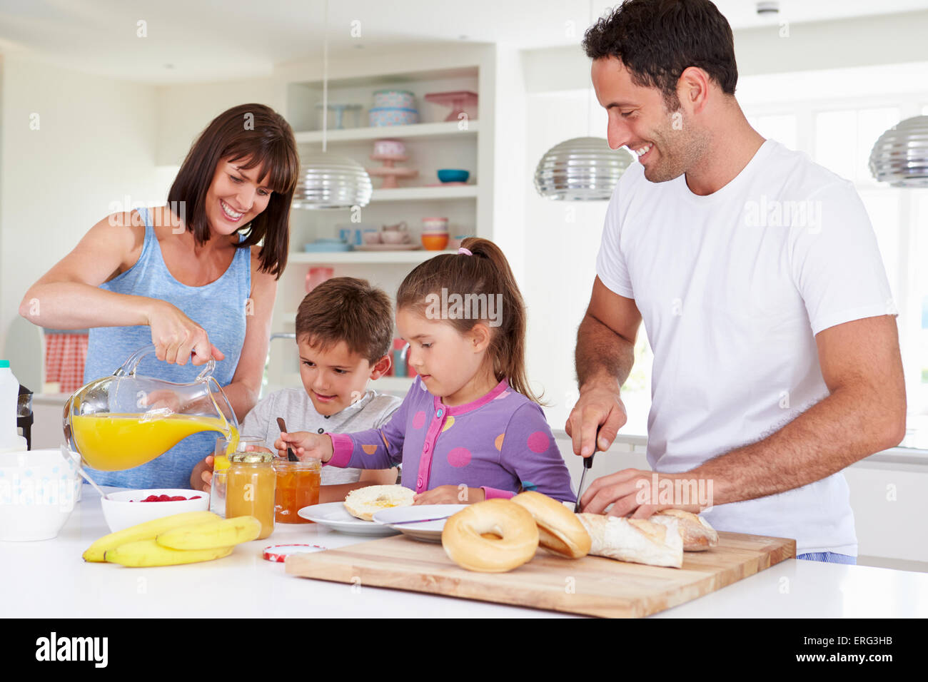 Family Making Breakfast In Kitchen Together Stock Photo - Alamy