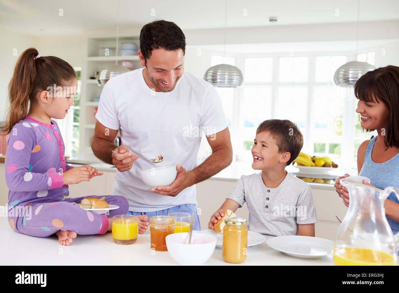 Family Eating Breakfast In Kitchen Together Stock Photo - Alamy
