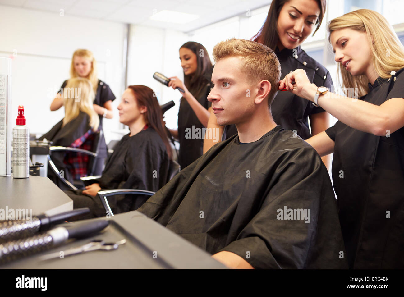 Teacher Helping Students Training To Become Hairdressers Stock Photo ...