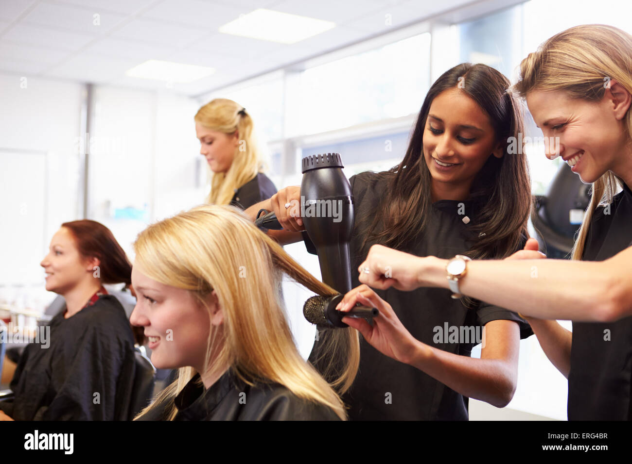 Teacher Helping Students Training To Become Hairdressers Stock Photo ...