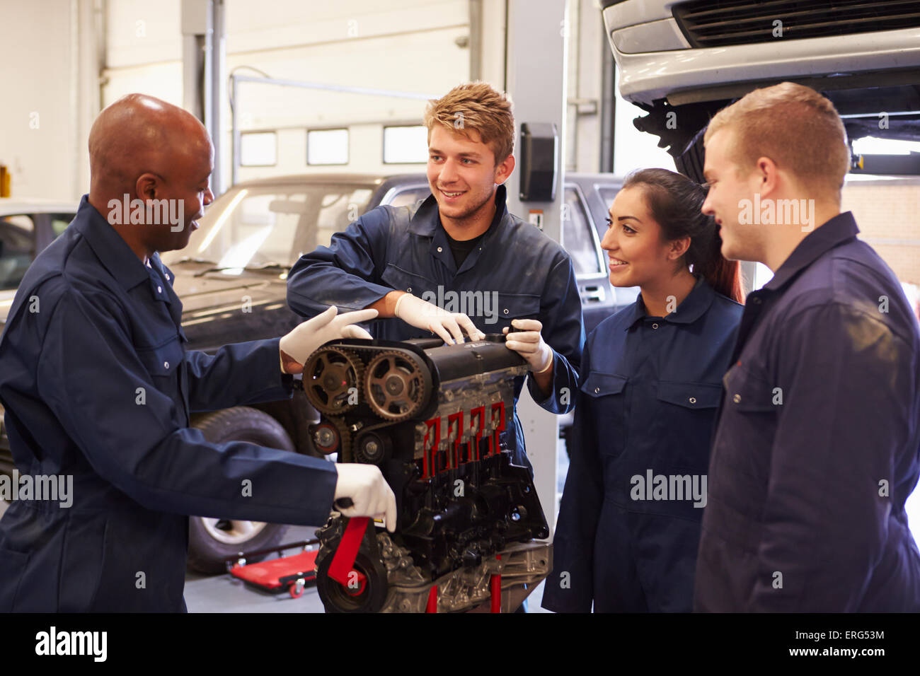 Teacher Helping Students Training To Be Car Mechanics Stock Photo - Alamy
