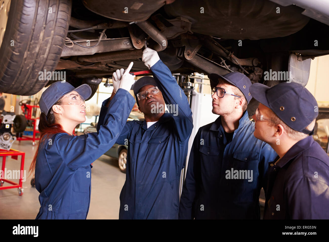 Teacher Helping Students Training To Be Car Mechanics Stock Photo - Alamy