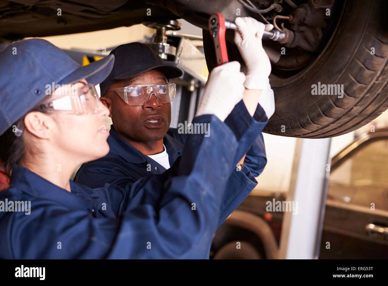 Teacher Helping Student Training To Be Car Mechanics Stock Photo - Alamy