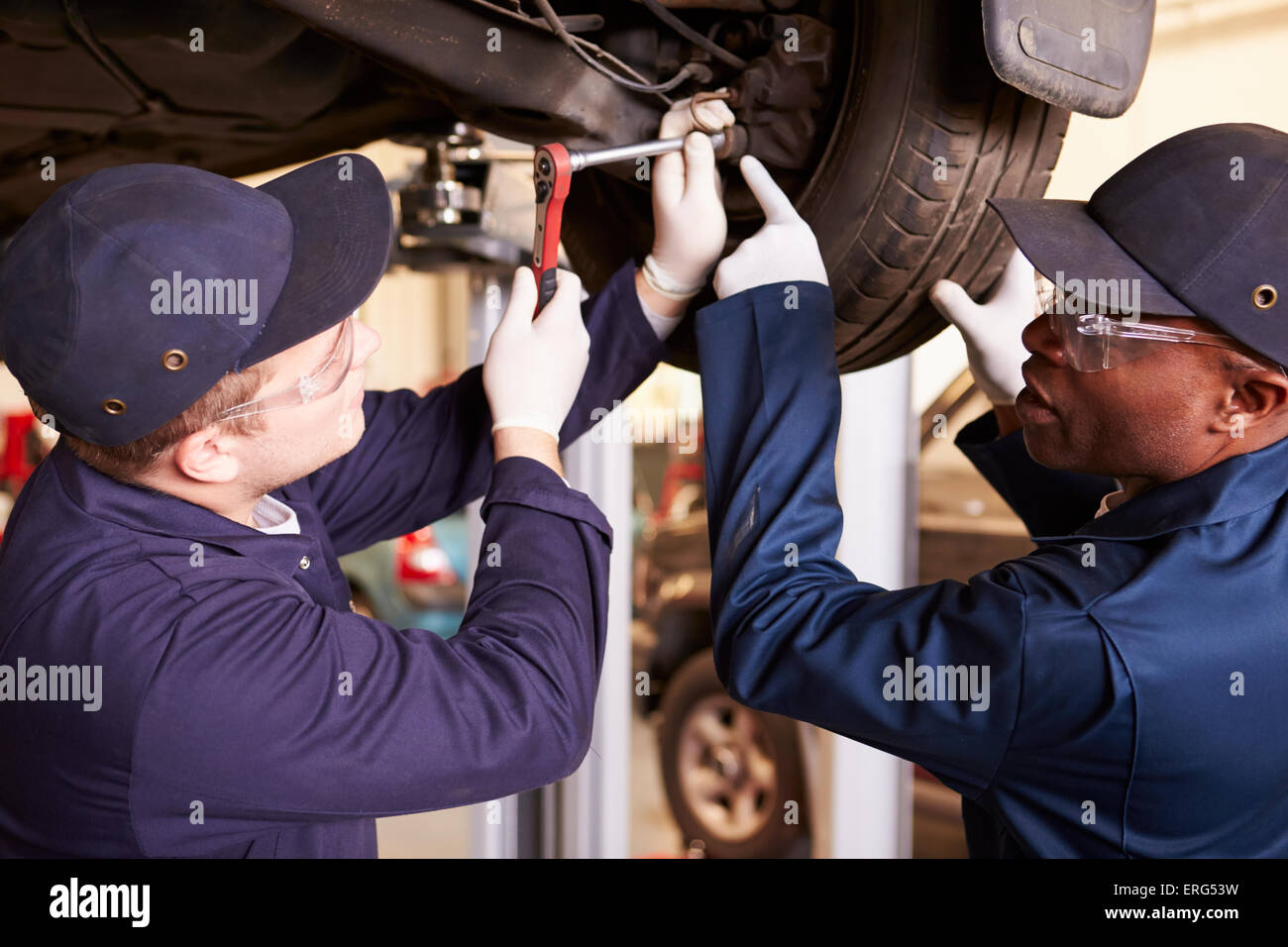 Teacher Helping Student Training To Be Car Mechanics Stock Photo - Alamy