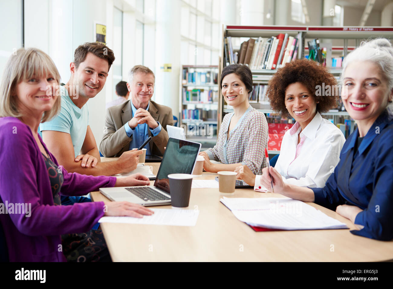 Group Of Mature Students Collaborating On Project In Library Stock ...