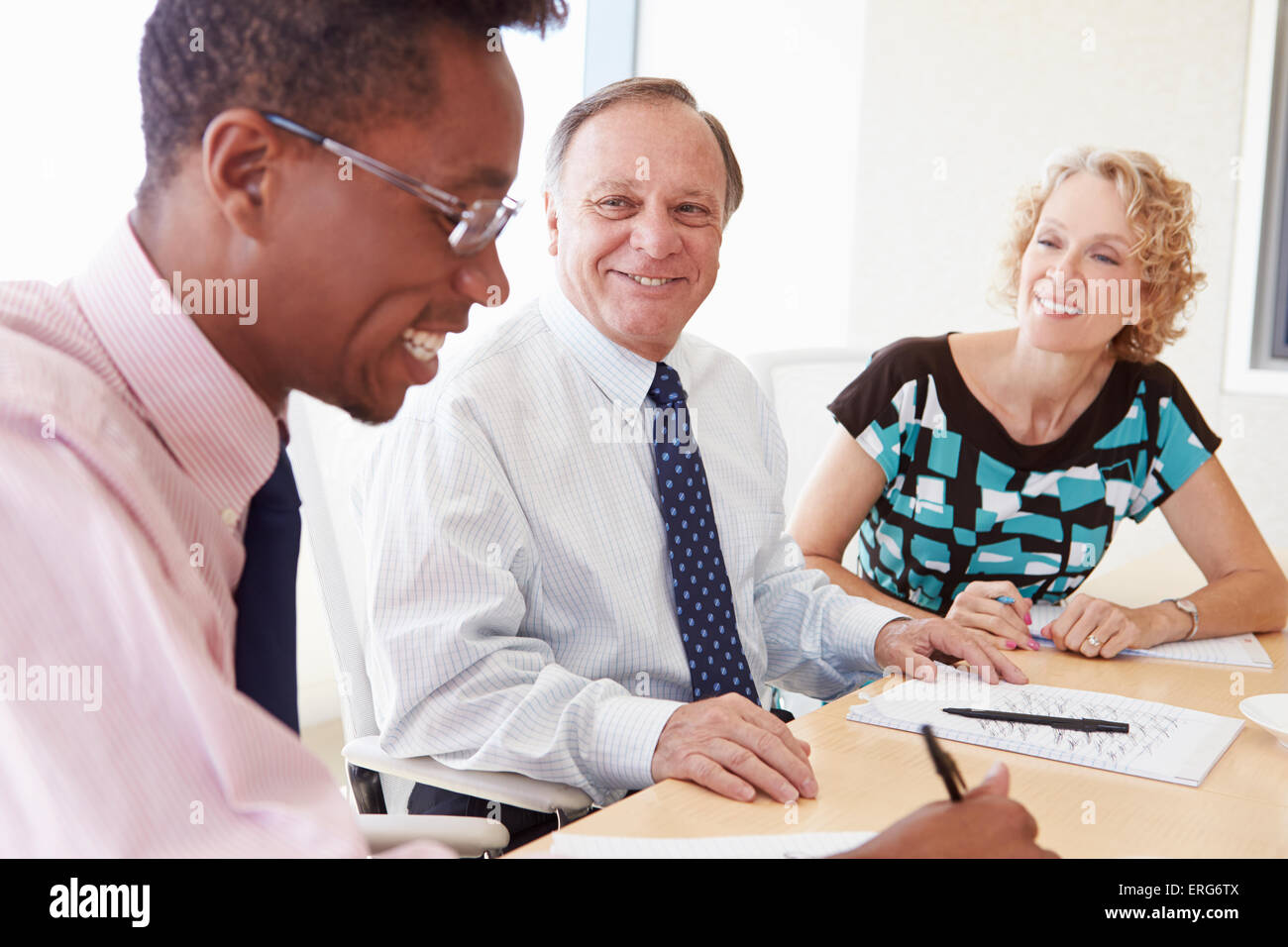 Three Businesspeople Having Meeting In Boardroom Stock Photo - Alamy