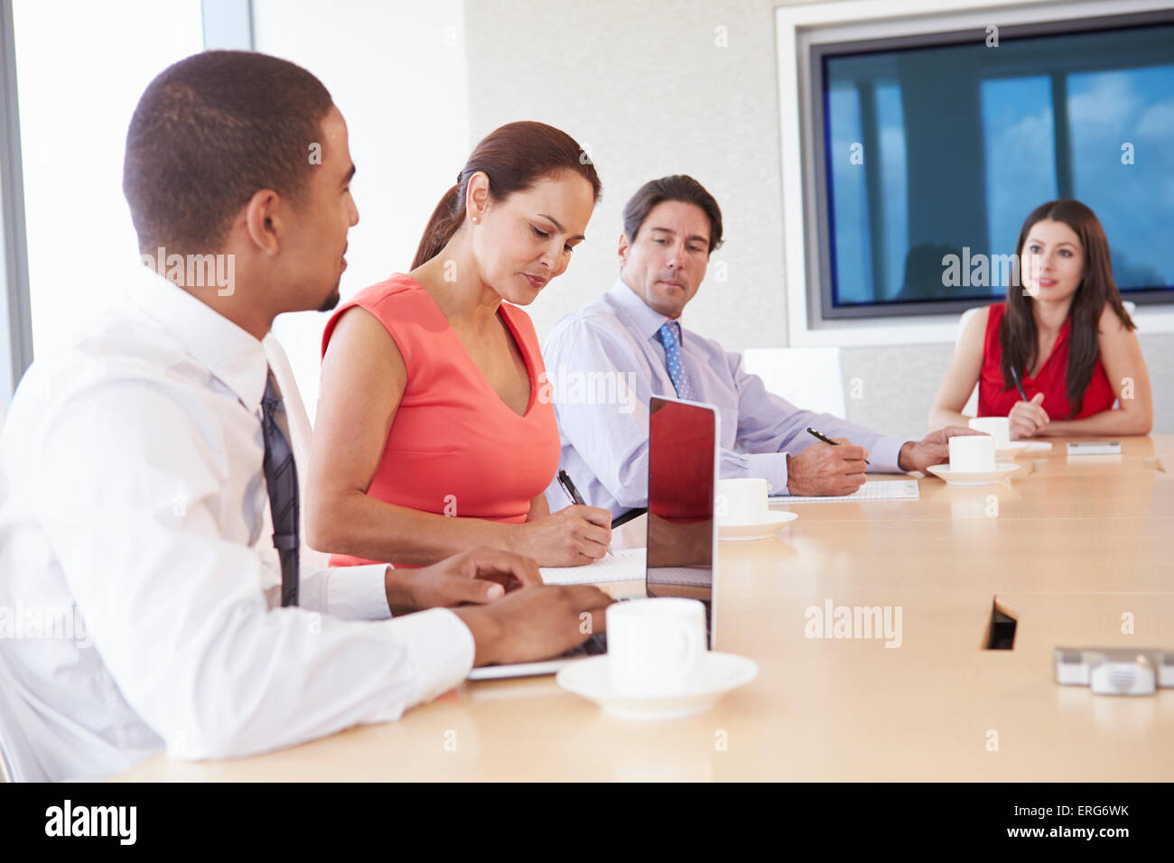 Four Hispanic Businesspeople Having Meeting In Boardroom Stock Photo ...