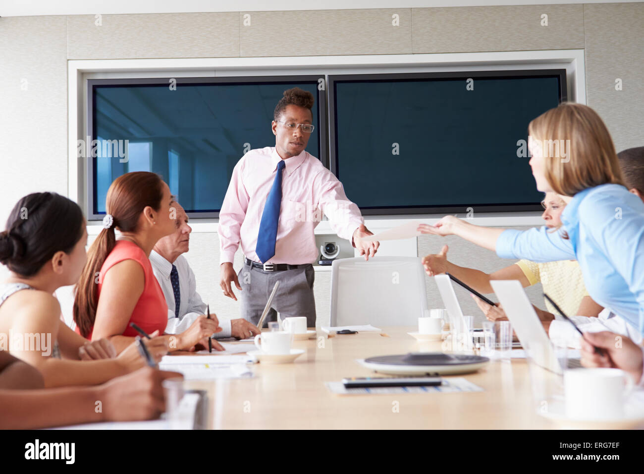 Group Of Businesspeople Meeting Around Boardroom Table Stock Photo - Alamy