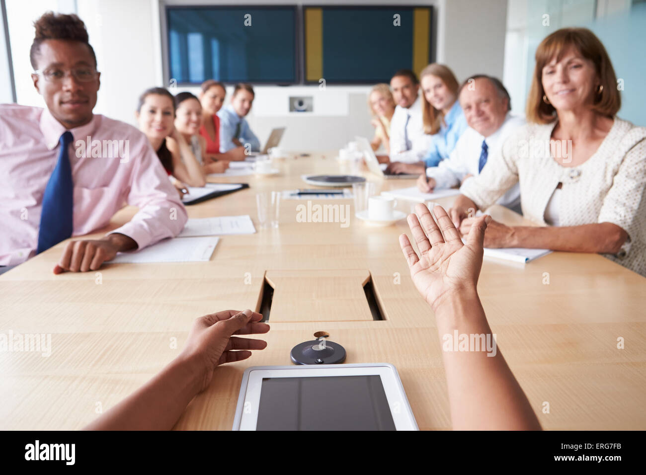 Point Of View Shot Of Businesspeople Around Boardroom Table Stock Photo ...