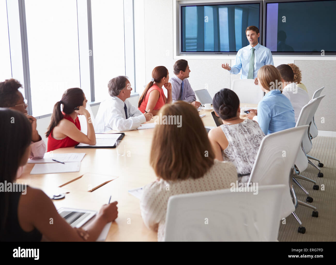 Group Of Businesspeople Meeting Around Boardroom Table Stock Photo - Alamy