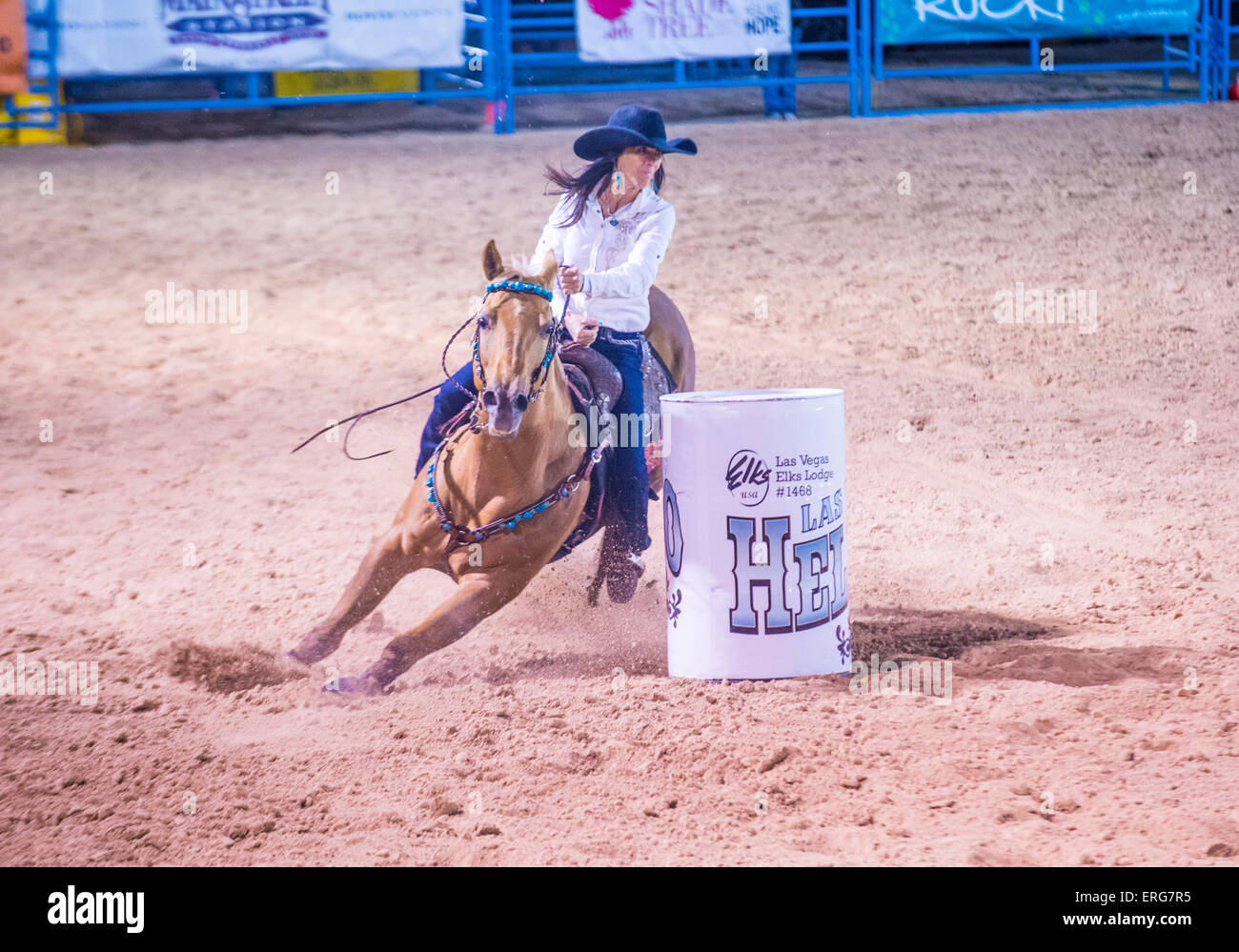 Cowgirl Participating in a Barrel racing competition at the Helldorado ...