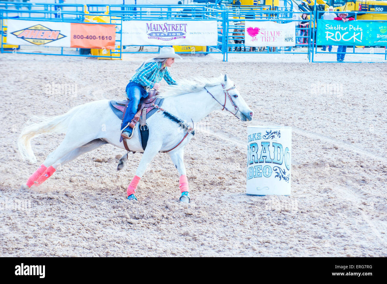 Cowgirl Participating in a Barrel racing competition at the Helldorado ...