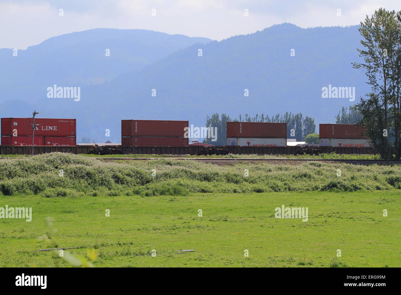 Railway Box Cars traveling through rural country side Stock Photo - Alamy