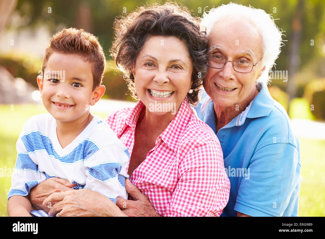 Grandparents Having Fun In Park With Grandson Stock Photo - Alamy