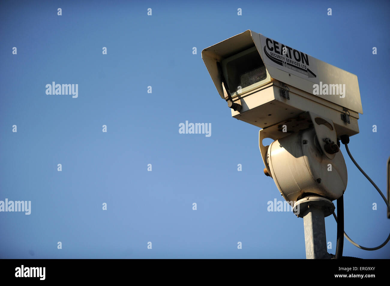 A CCTV security camera against a blue sky Stock Photo - Alamy