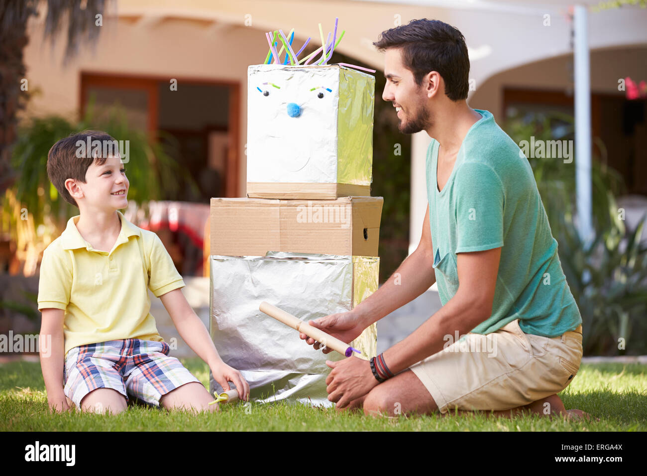 Father And Son Building Model Robot In Garden Stock Photo - Alamy