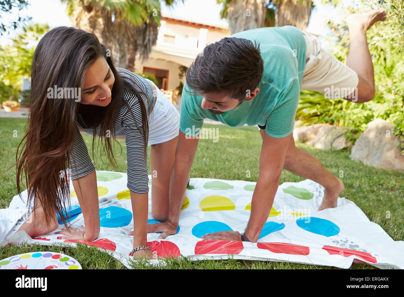 Young Couple Playing Balancing Game In Garden Stock Photo - Alamy