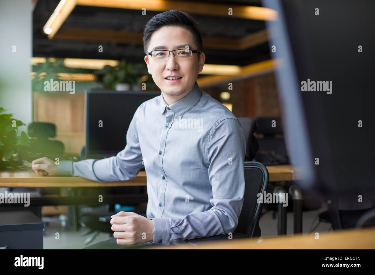 IT worker sitting in office Stock Photo - Alamy