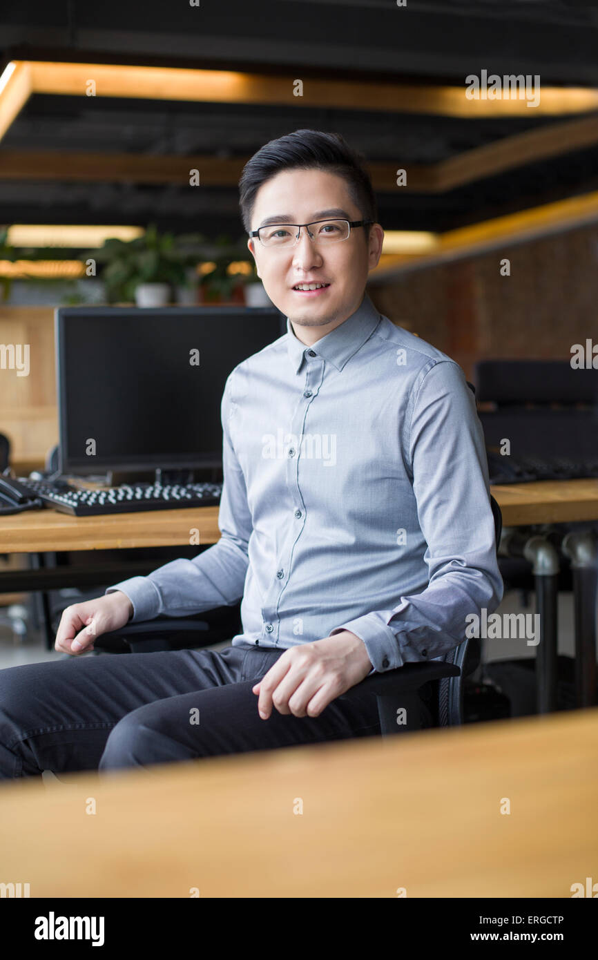IT worker sitting in office Stock Photo - Alamy